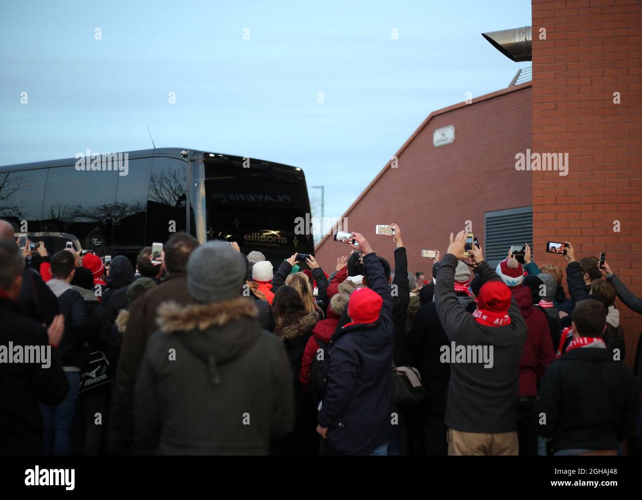 Liverpool's fans take photos on their phones on the team bus arriving ...