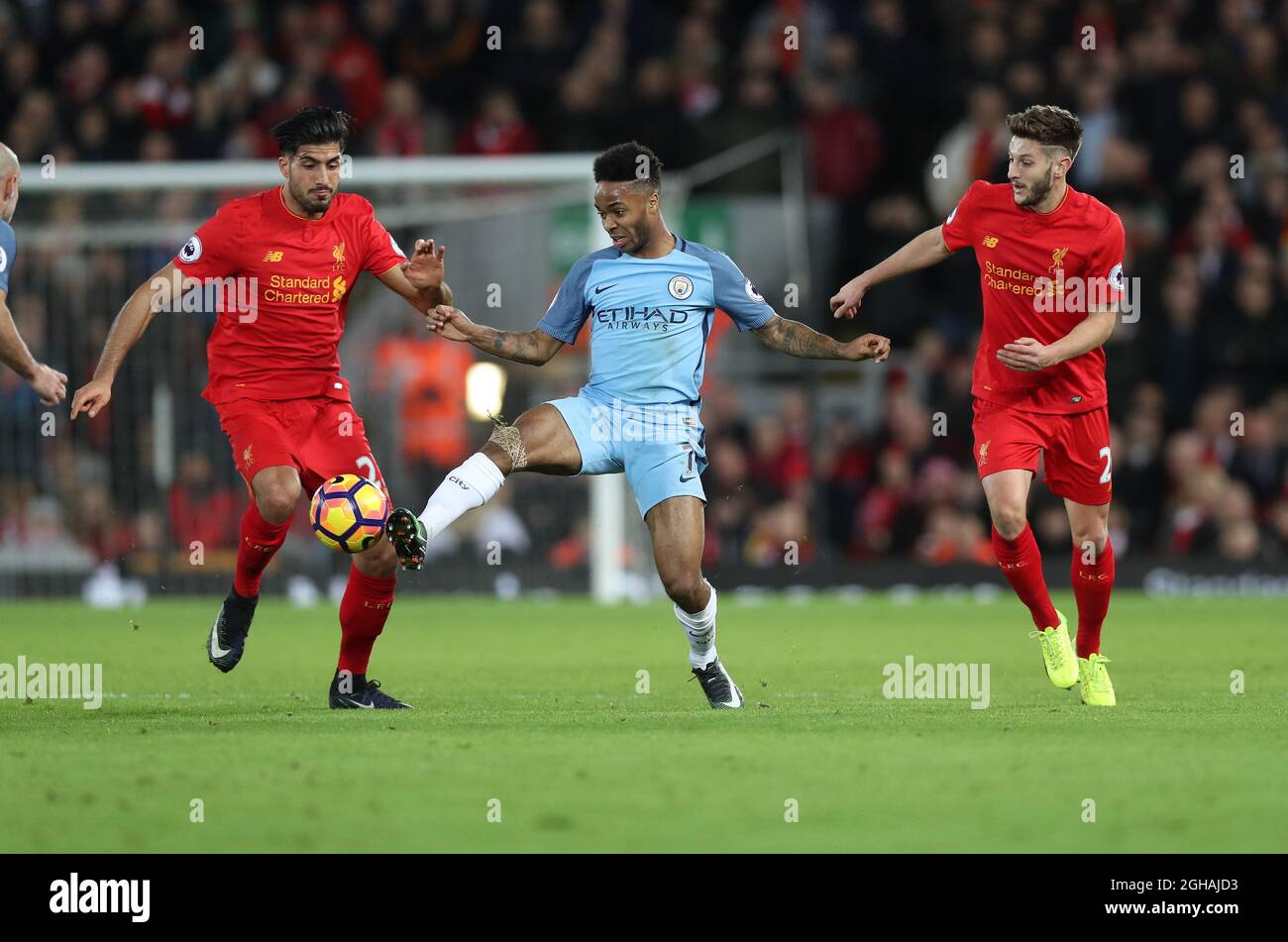 Raheem Sterling of Manchester City is tackled by Emre Can and Adam ...