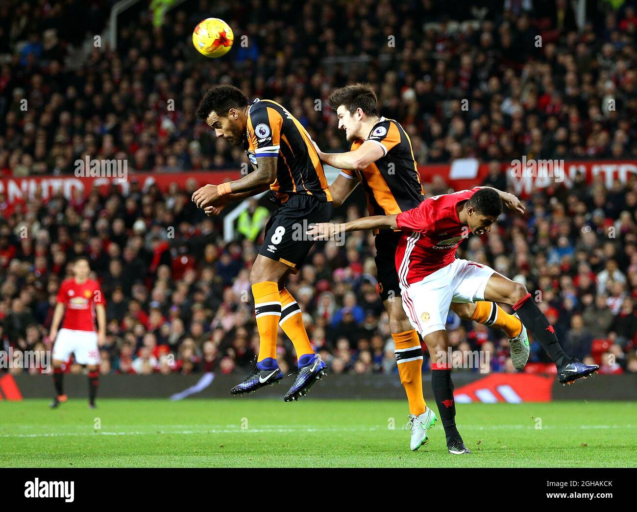 Tom Huddlestone of Hull City wins a header above Marcus Rashford of ...