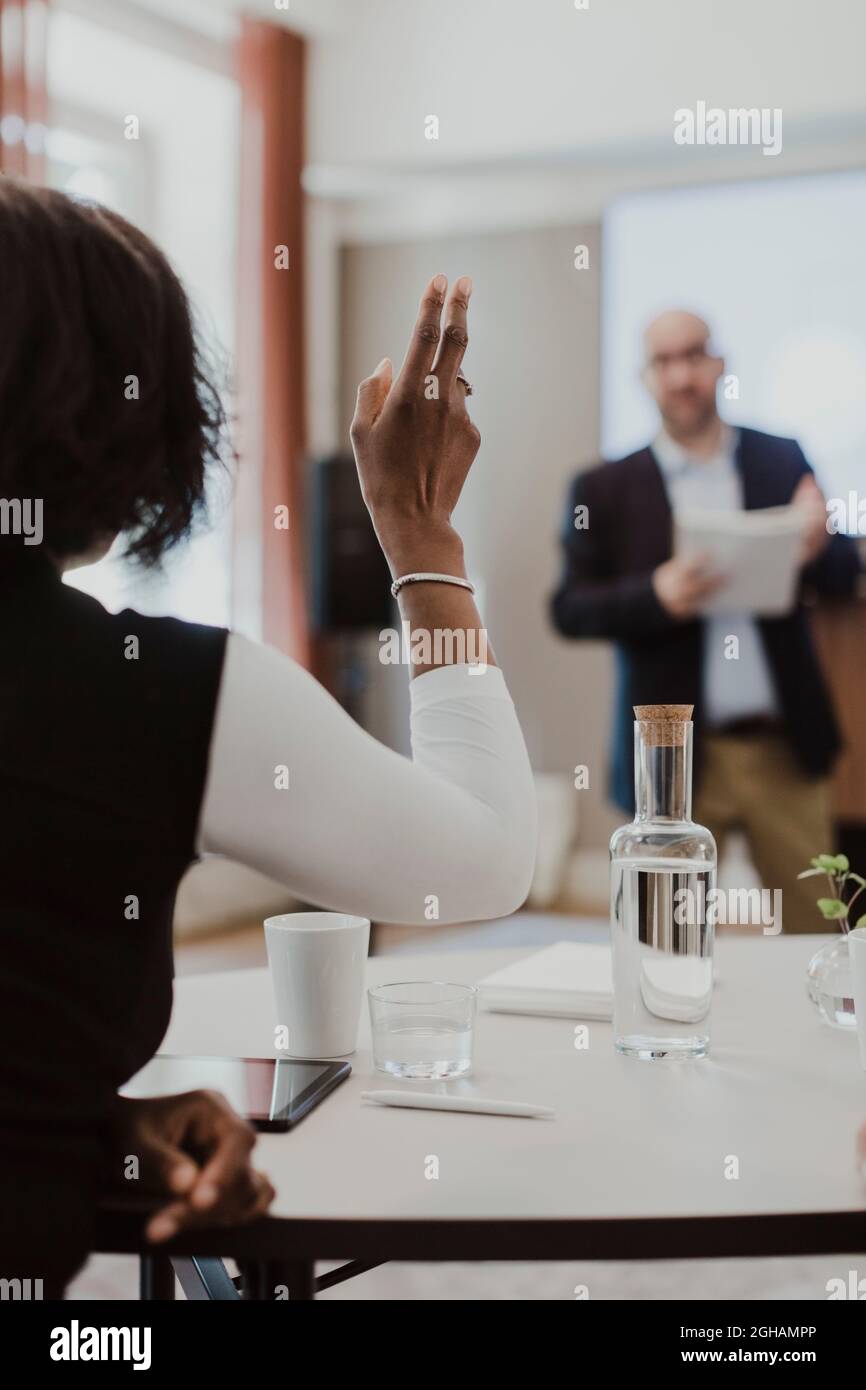 Female entrepreneur asking question while male colleague giving ...