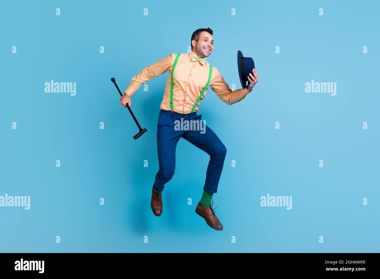 Profile photo of active guy jump hold cane run wear suspenders shirt ...