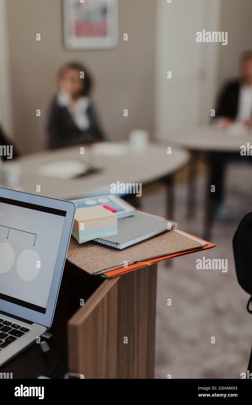 Laptop over desk in corporate office Stock Photo - Alamy