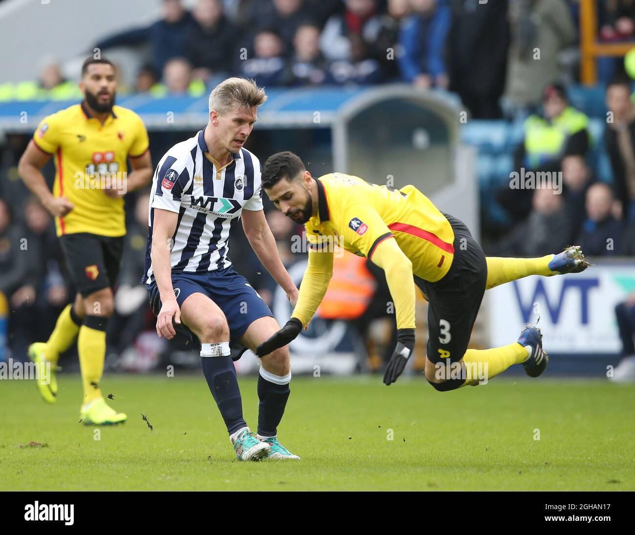 Millwall's Steve Morison kicks Watford's Miguel Britos off the ball ...