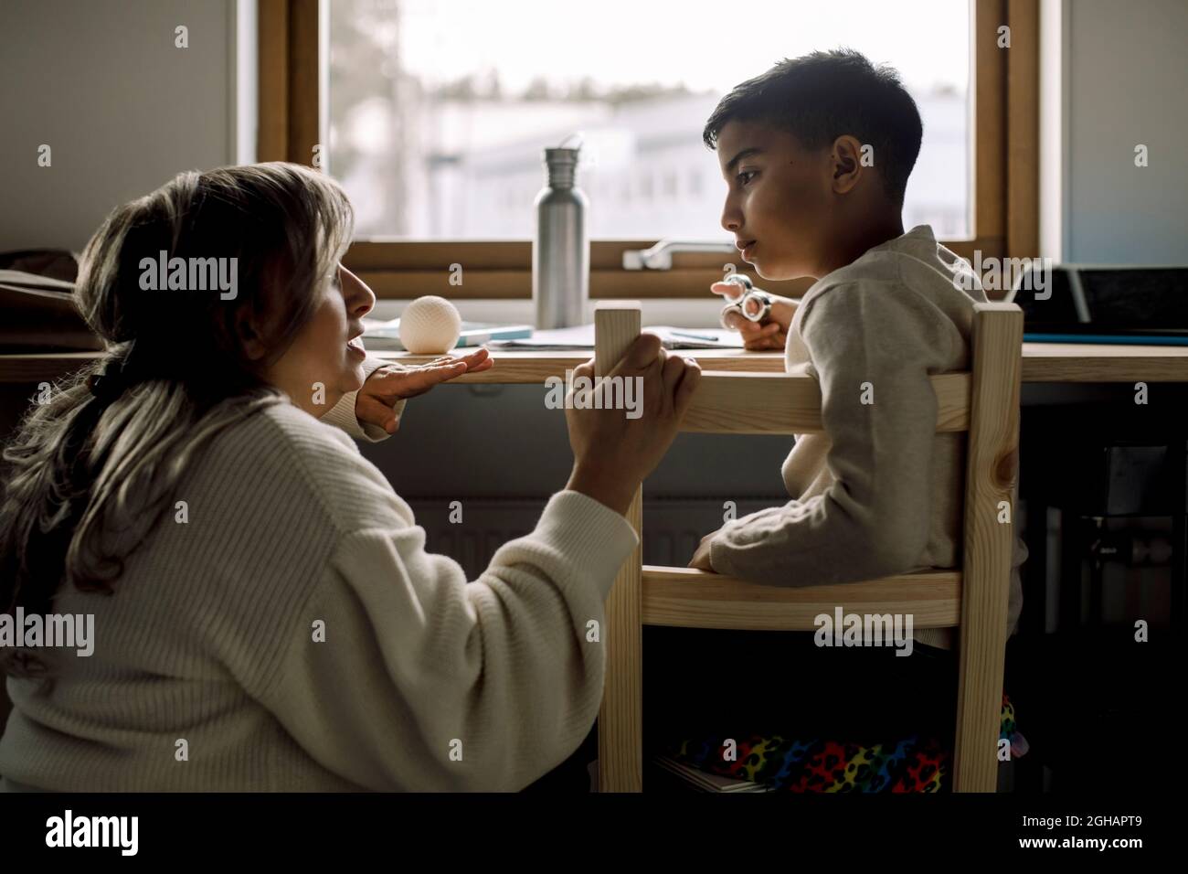 Mother and son talking with each other at home Stock Photo - Alamy
