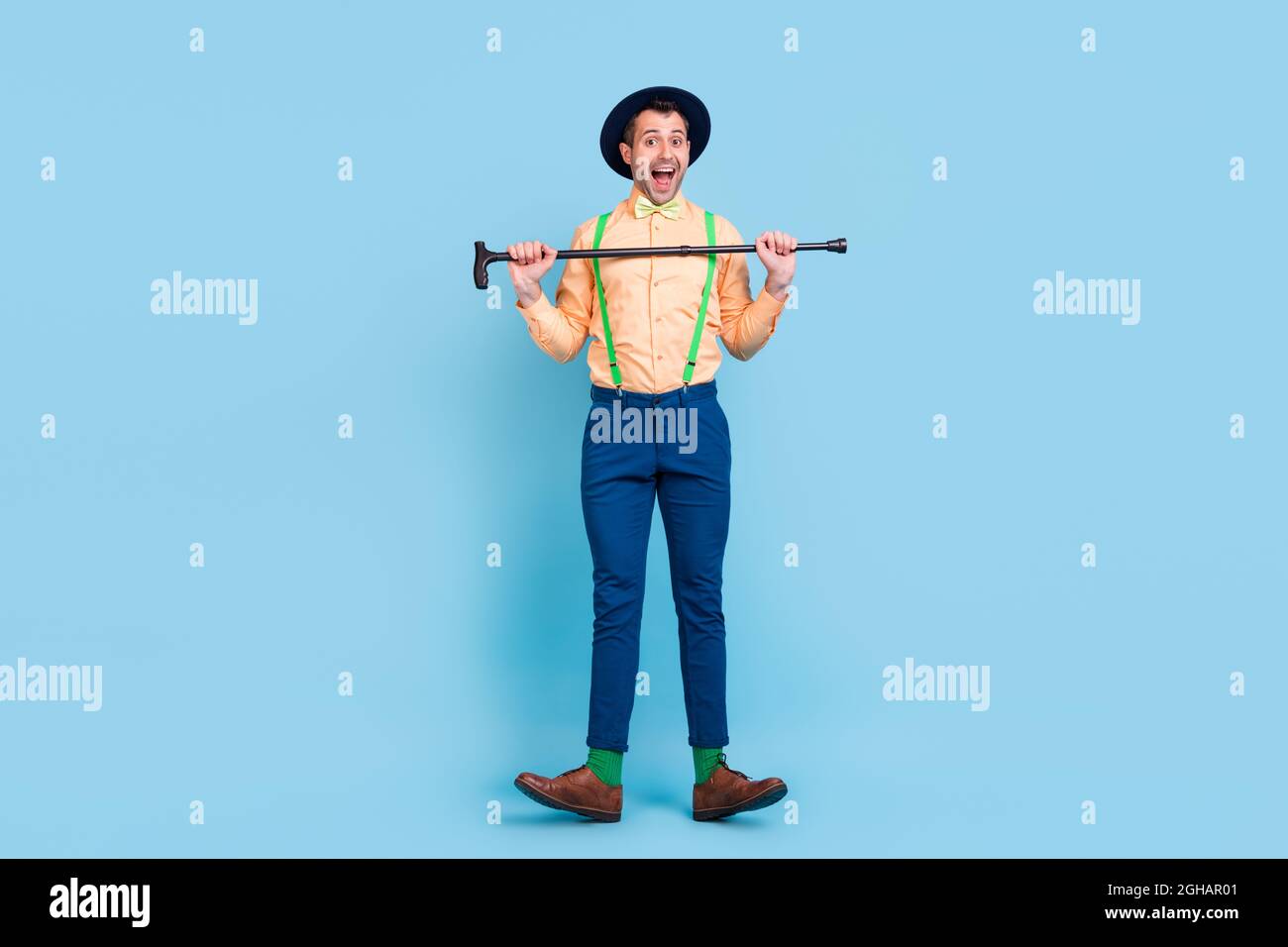 Photo of crazy dancer guy hold cane dance open mouth wear hat ...