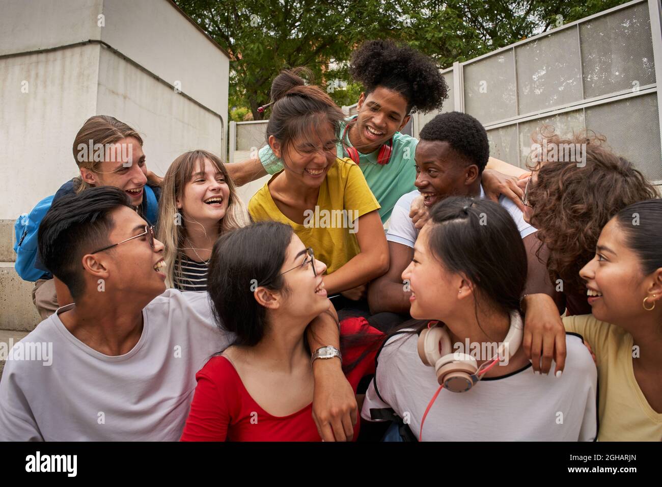 A group of students having fun outside. Happy classmates at the high ...