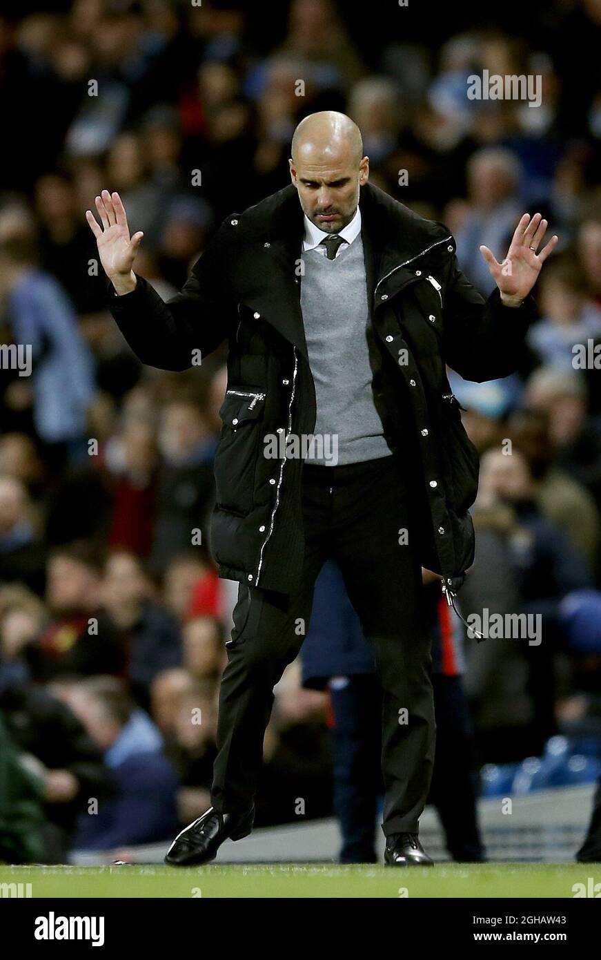Josep Guardiola manager of Manchester City holds up his hands during ...