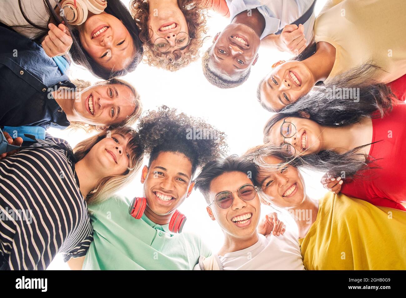 Low angle of a group of students are together, happy and smiling. Faces ...