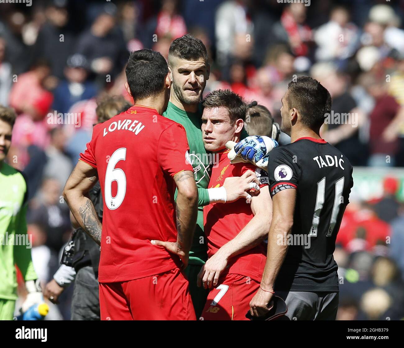 Fraser Forster of Southampton hugs James Milner of Liverpool during the ...