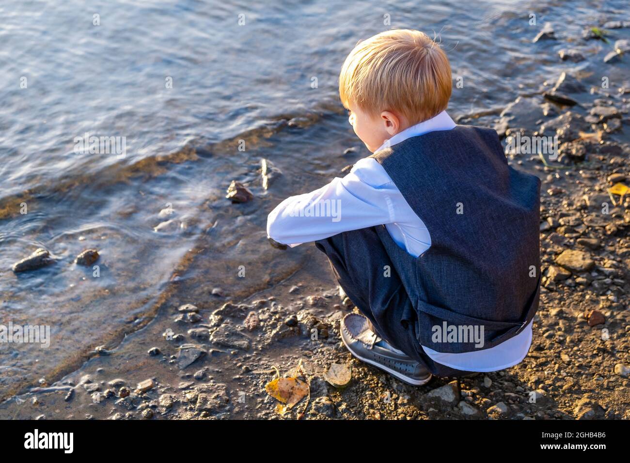Small Boy looking on the Water outdoor Stock Photo - Alamy