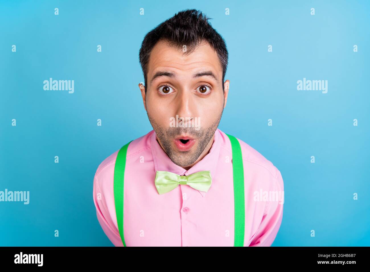Photo of impressed brunet hairdo man look wear pink shirt isolated on ...
