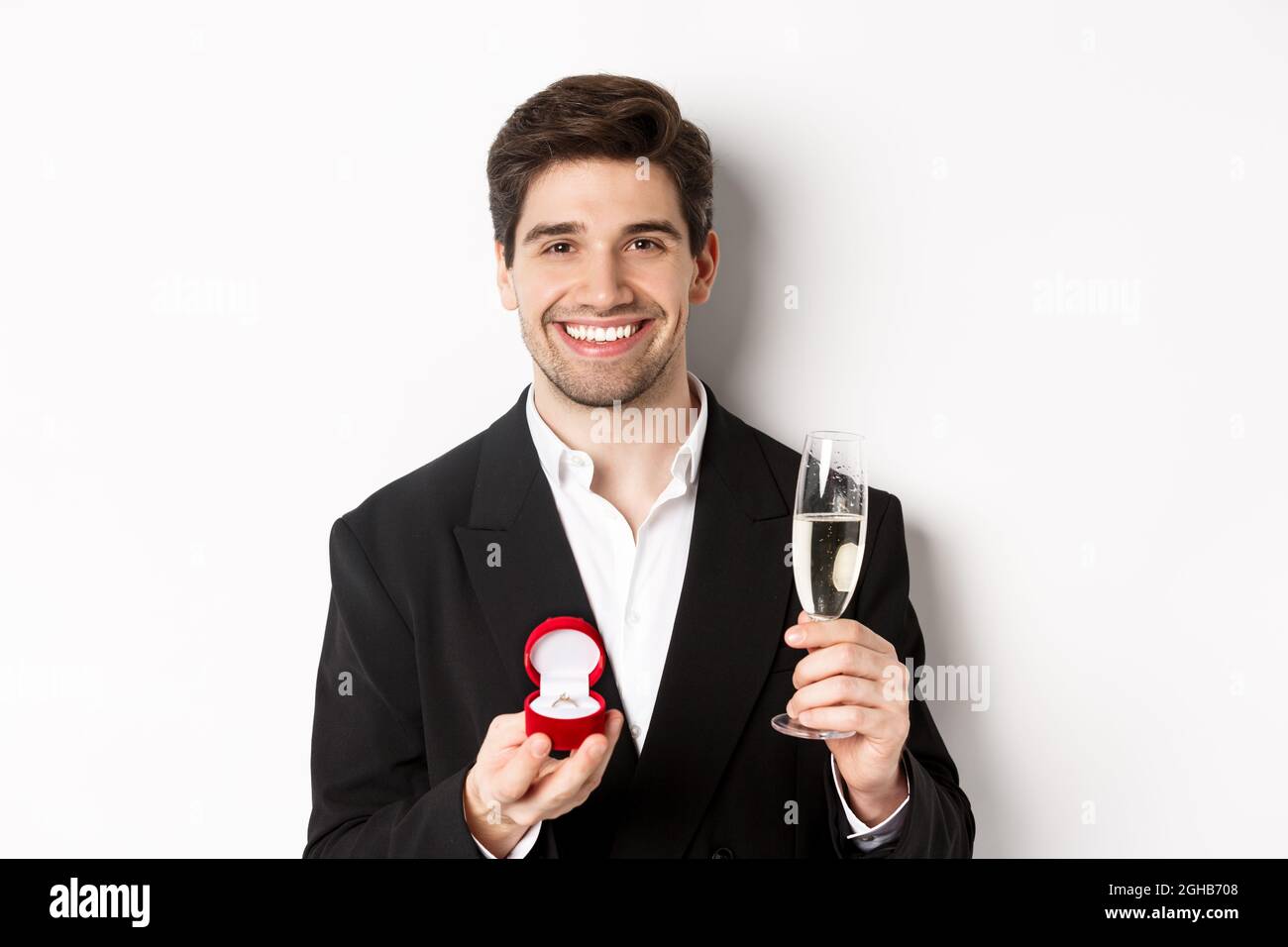 Close-up of handsome man in suit, making a proposal, giving engagement ...
