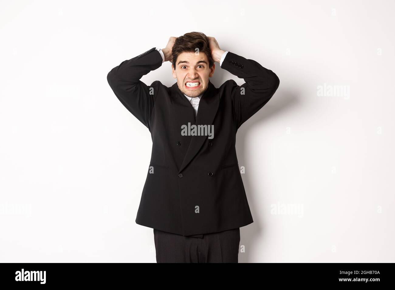 Image of frustrated and angry businessman in black suit, ripping hair ...