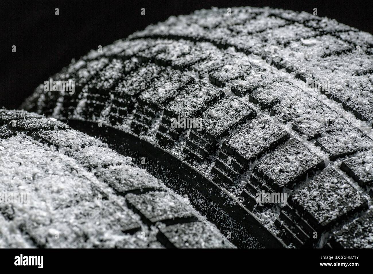 Winter Car tires with snow close-up wheel profile structure on black background Stock Photo - Alamy
