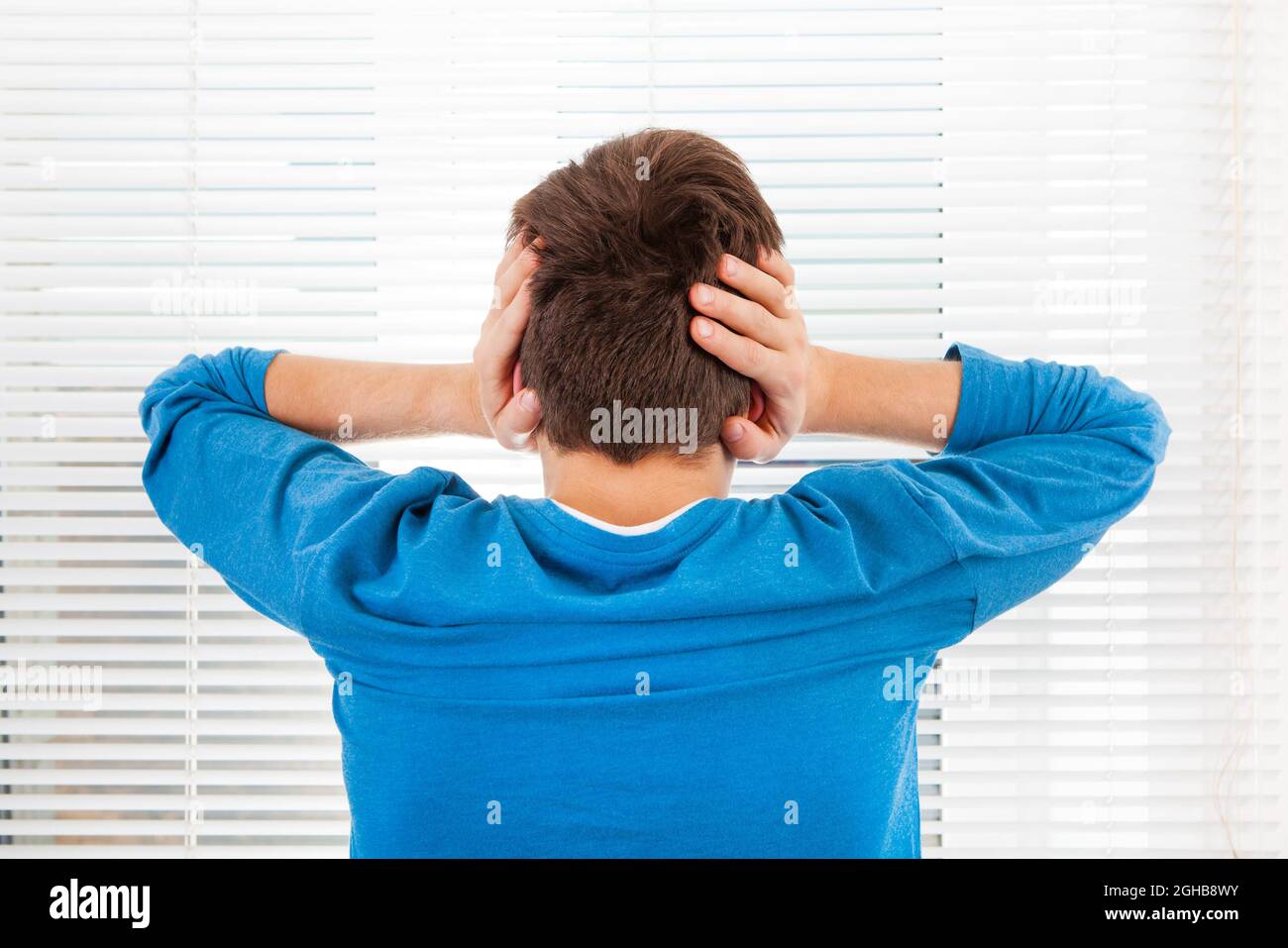 Rear View of a Man Covering his Ears from a Noise in the Room Stock ...