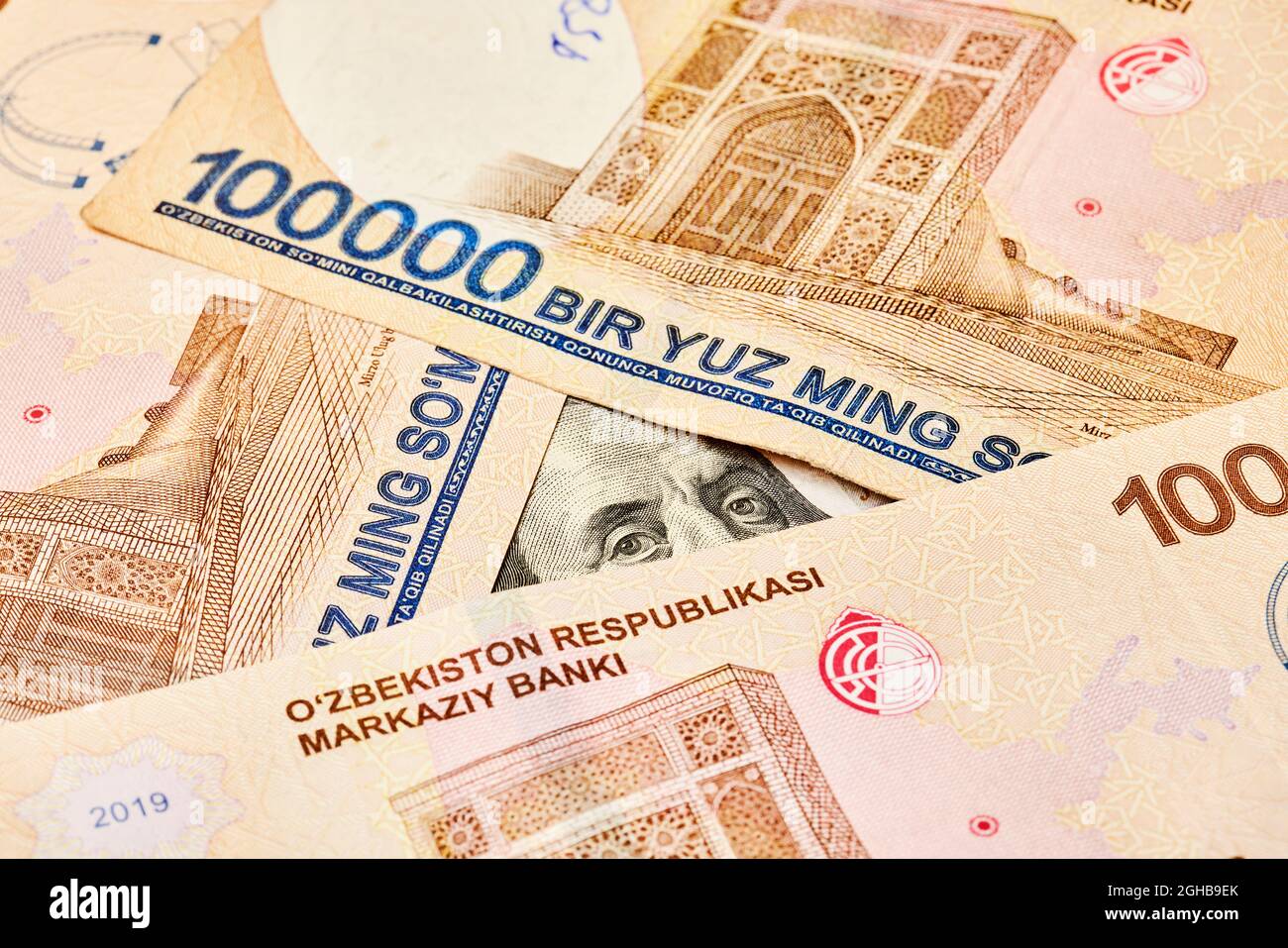 US dollar banknote and Uzbek sums. Concept of exchange rate, Uzbek sum ...