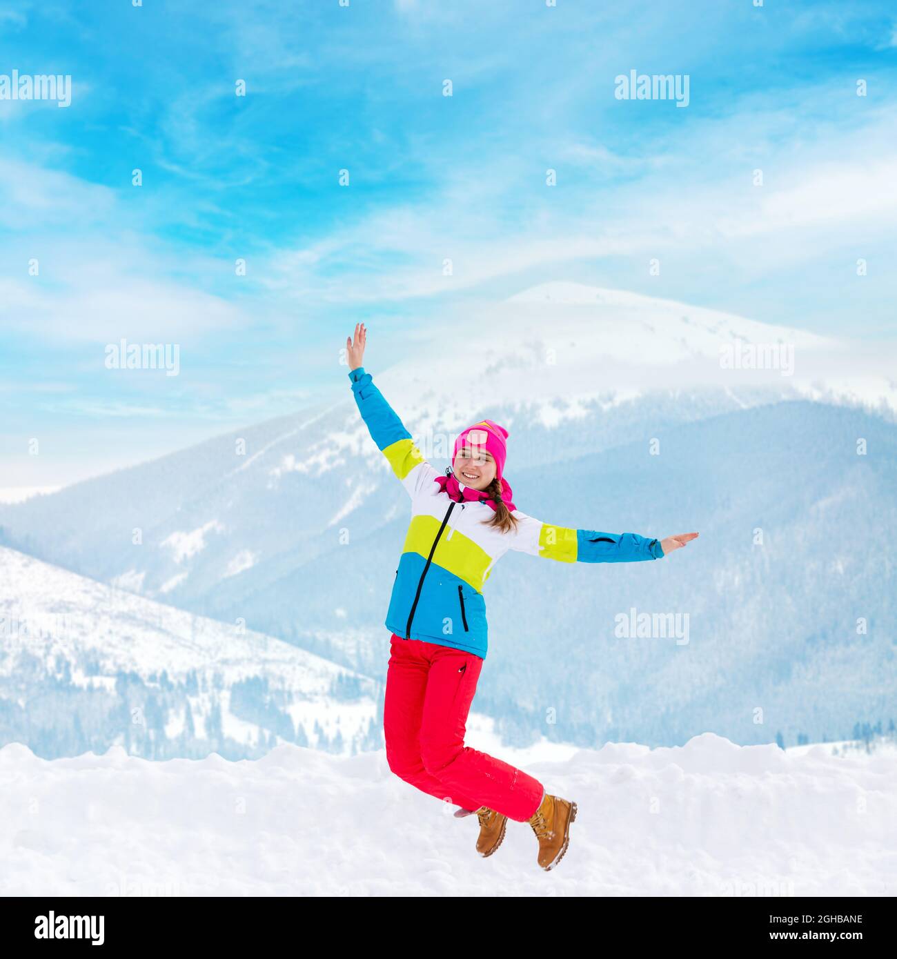Young excited teenage girl in the mountains in winter. Winter vacation ...