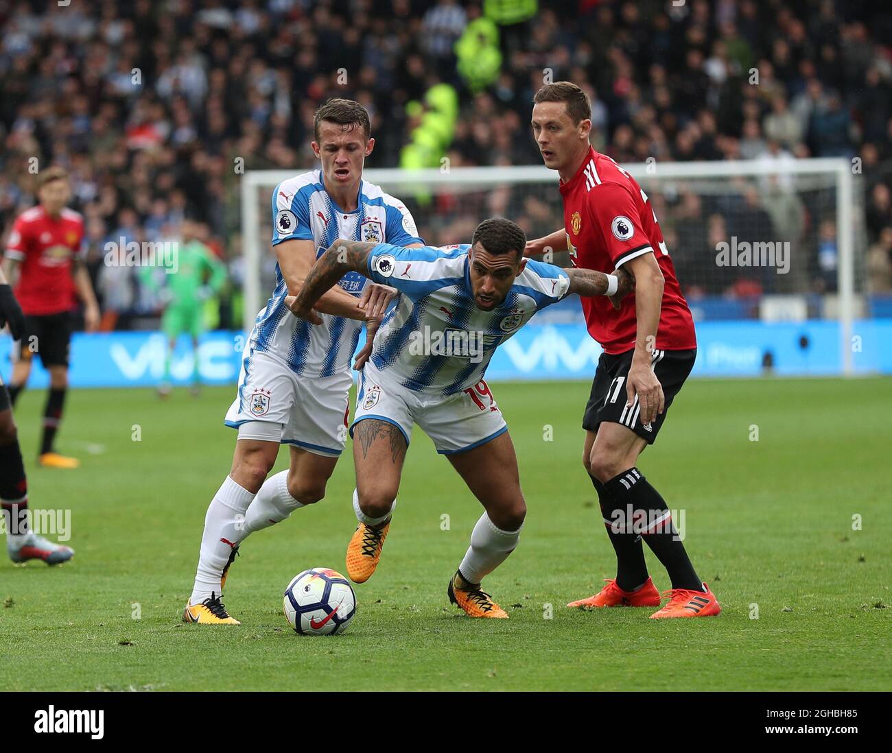 Daniel Williams of Huddersfield in action with Nemanja Matic of ...
