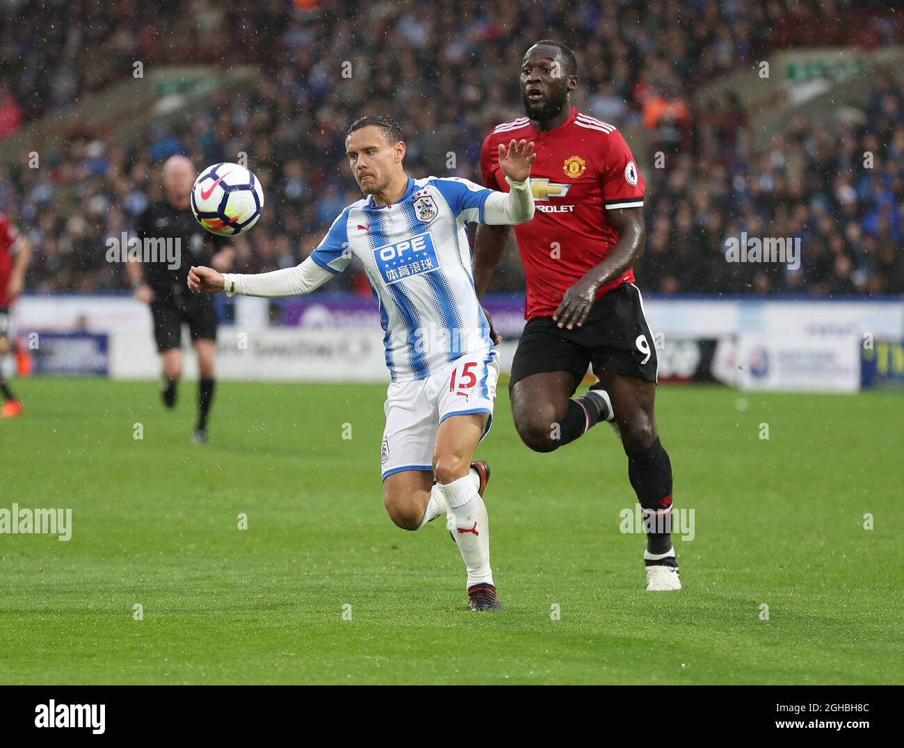 Chris Lowe of Huddersfield in action with Romelu Lukaku of Manchester ...