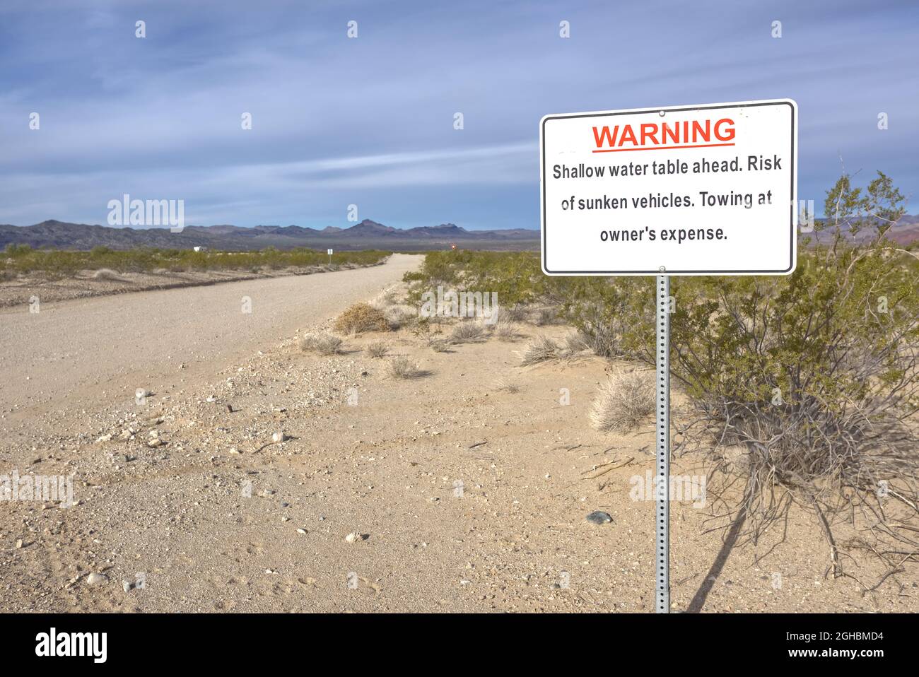 Road of Sinking Sands. A warning sign on a road that leads to Alamo ...