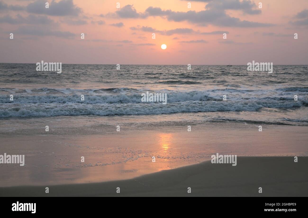 Pink sunset on Varсa beach in South Goa in India Stock Photo - Alamy