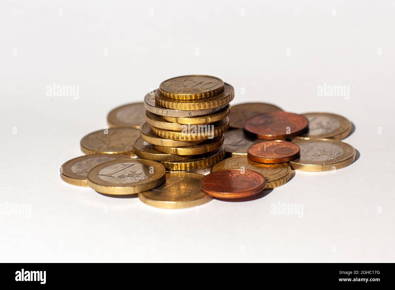 Stack of euro coins and white background Stock Photo - Alamy