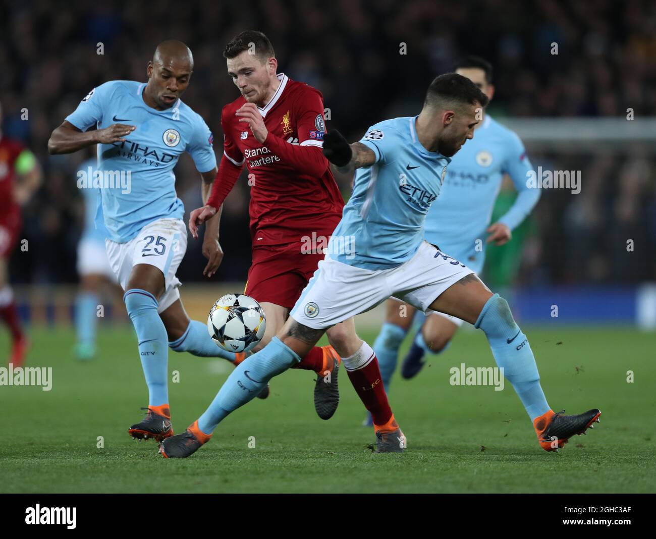 Andrew Robertson of Liverpool goes between Fernandinho of Manchester ...