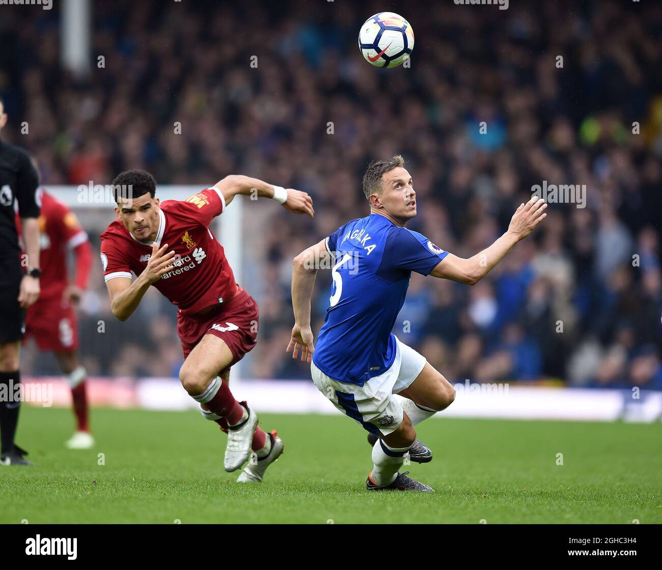 Phil Jagielka of Everton is challenged by Dominic Solanke of Liverpool ...