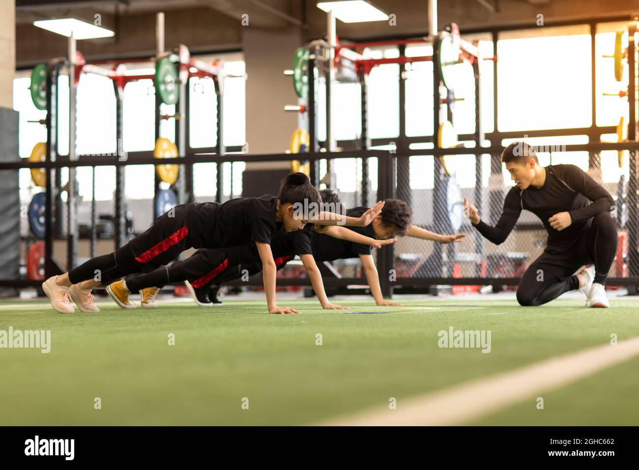 Active children having exercise class with their coach in gym Stock ...