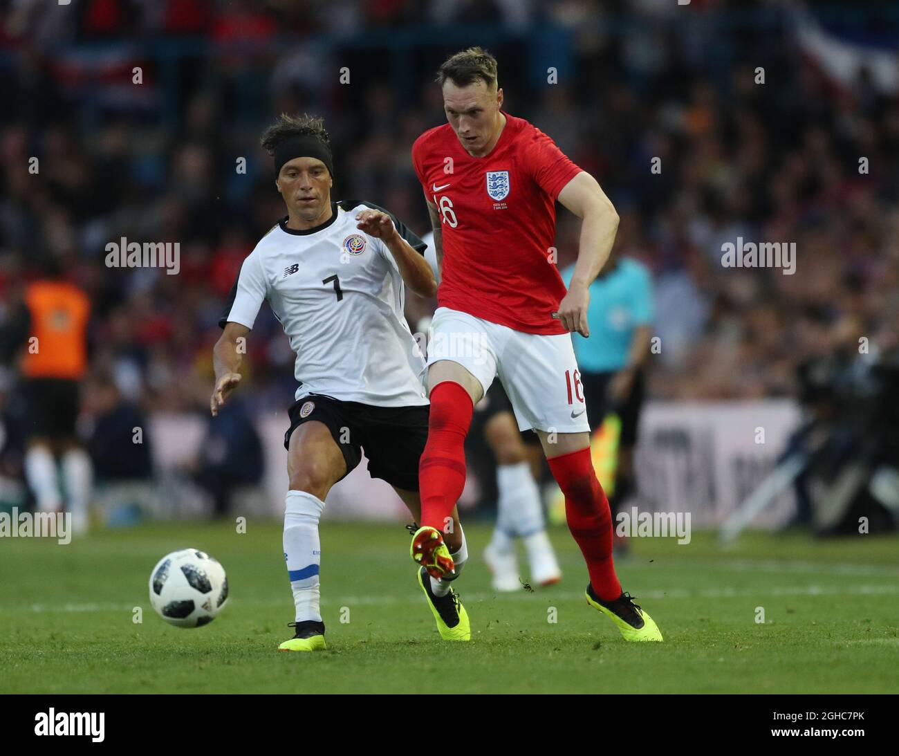 Phil Jones of England tussles with Christian Bolanos of Costa Rica ...