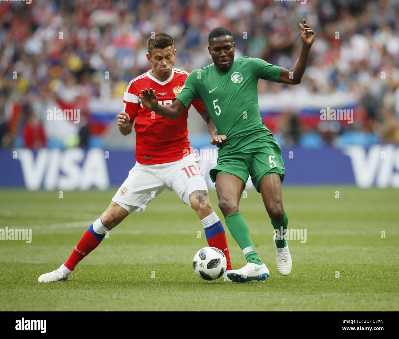Fedor Smolov of Russia tackles Othman Omar of Saudi Arabia during the ...