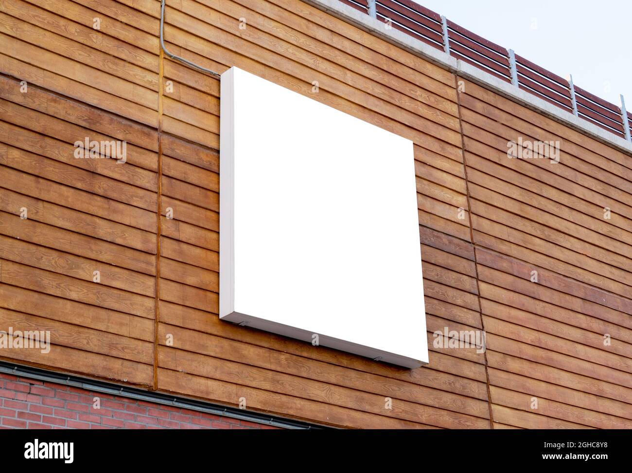 White square billboard on building wall for mockup, poster design ...