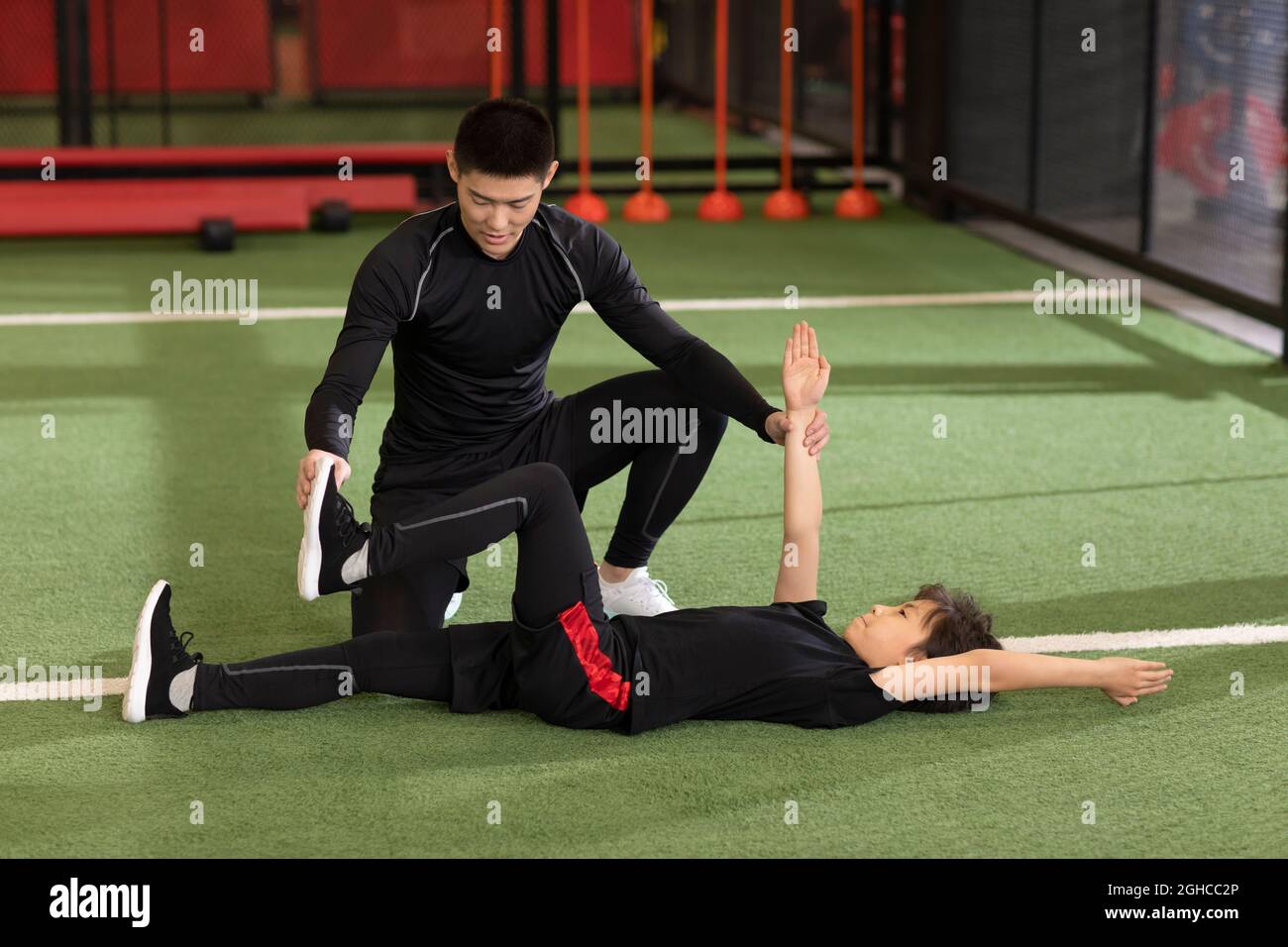 Little boy having exercise class with coach in gym Stock Photo - Alamy