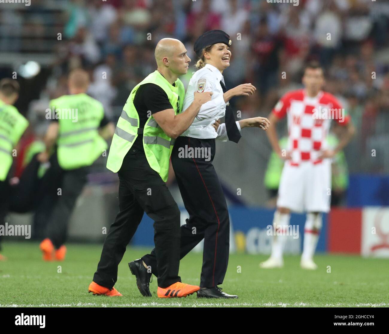 A pitch invader is escorted of the pitch the first time a final had ...