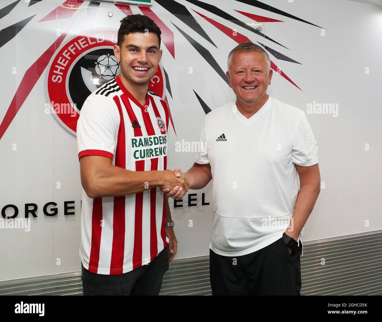 John Egan signs for Sheffield Utd and poses for pictures with manager ...