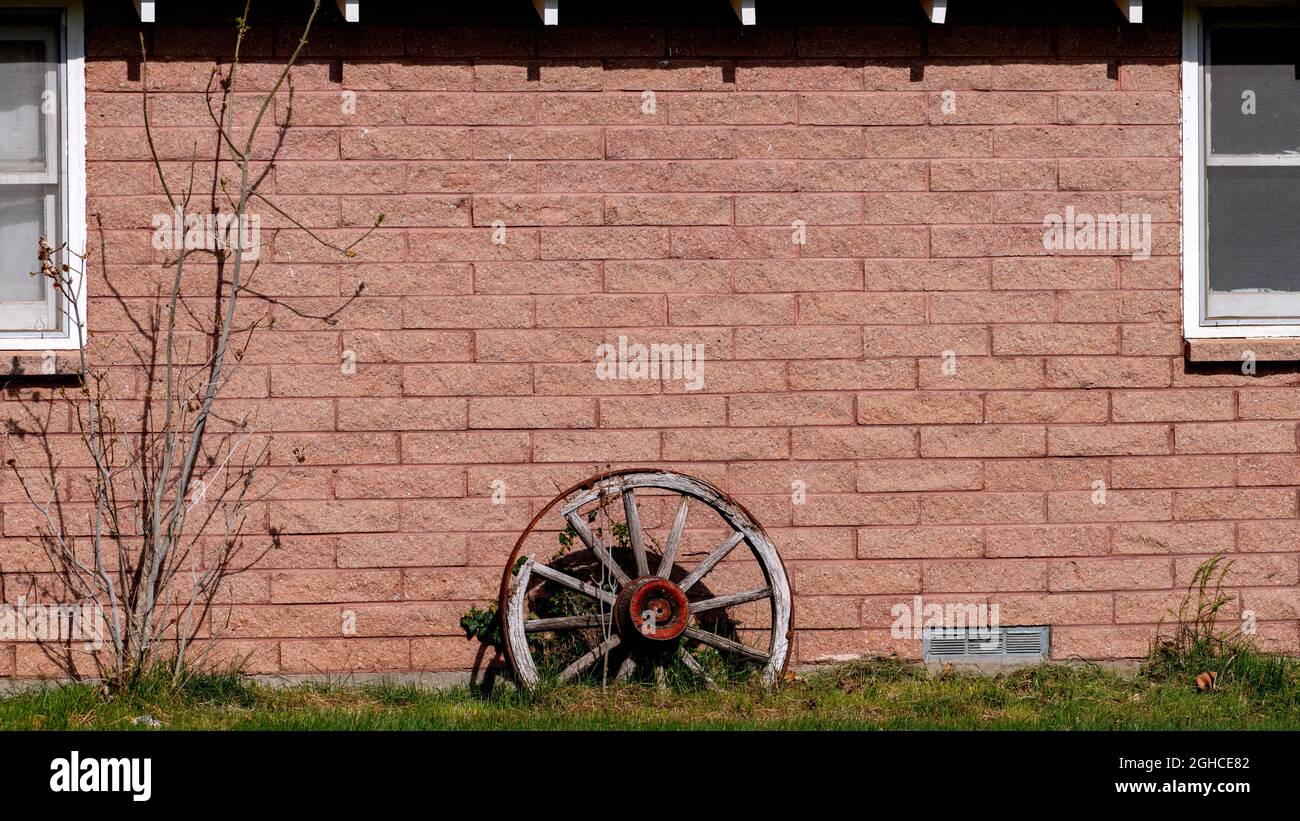 Flat images of a wagon wheel and brick wall Stock Photo - Alamy