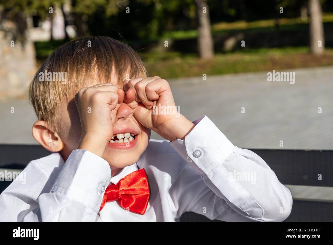 Kid close his Eyes with a Hands outdoor Stock Photo - Alamy