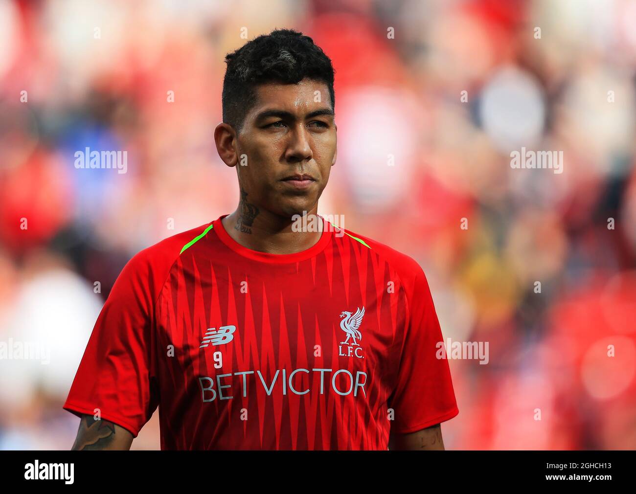 Liverpool's Roberto Firmino warms up during the Premier League match at ...