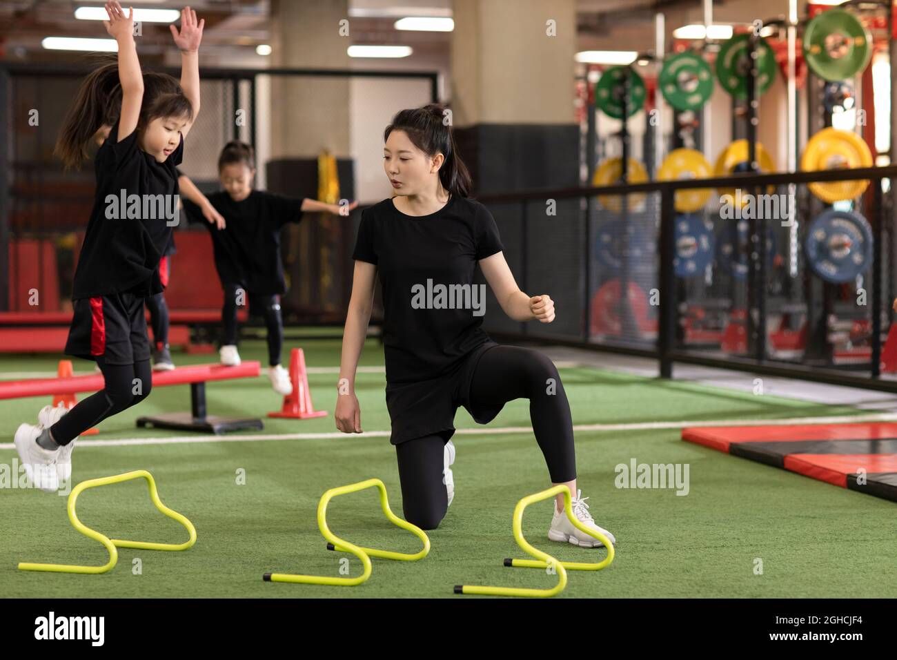 Active children having exercise class with their coach in gym Stock ...