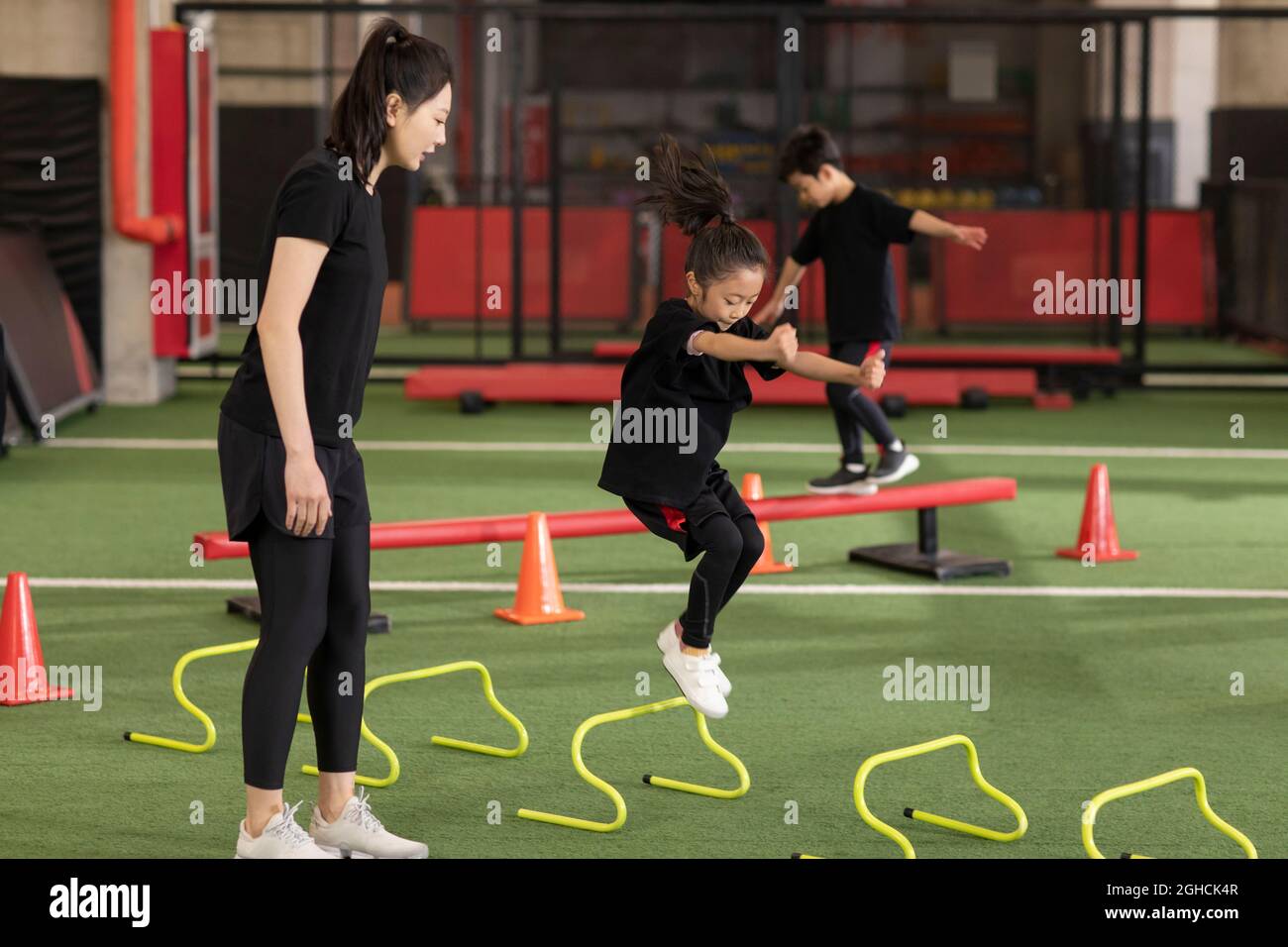 Active children having exercise class with their coach in gym Stock ...