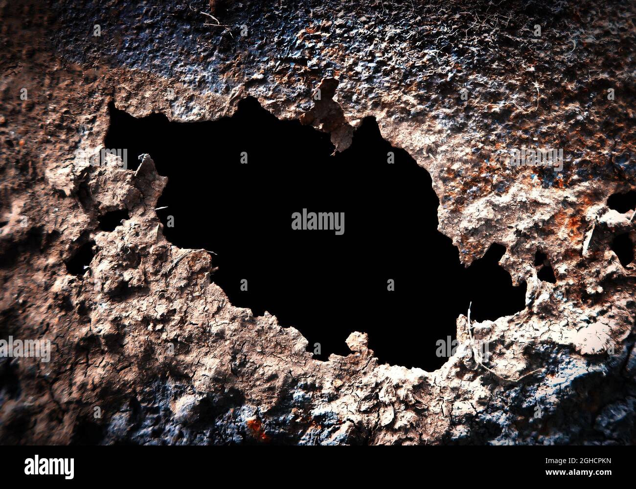 Hole in the Rusty Metal closeup Stock Photo - Alamy