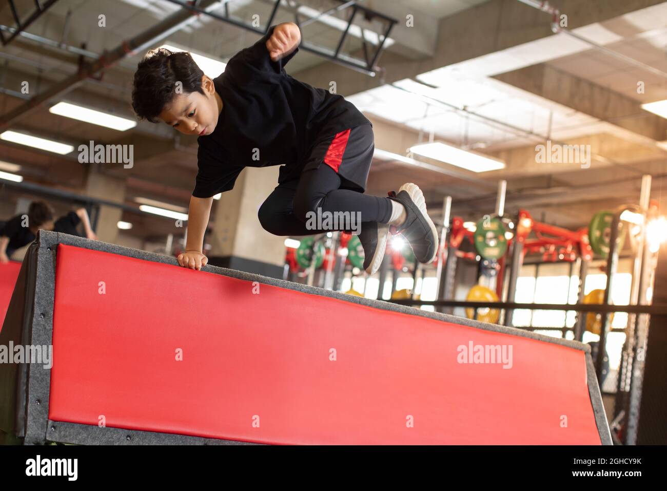 Active boy having exercise class in gym Stock Photo - Alamy