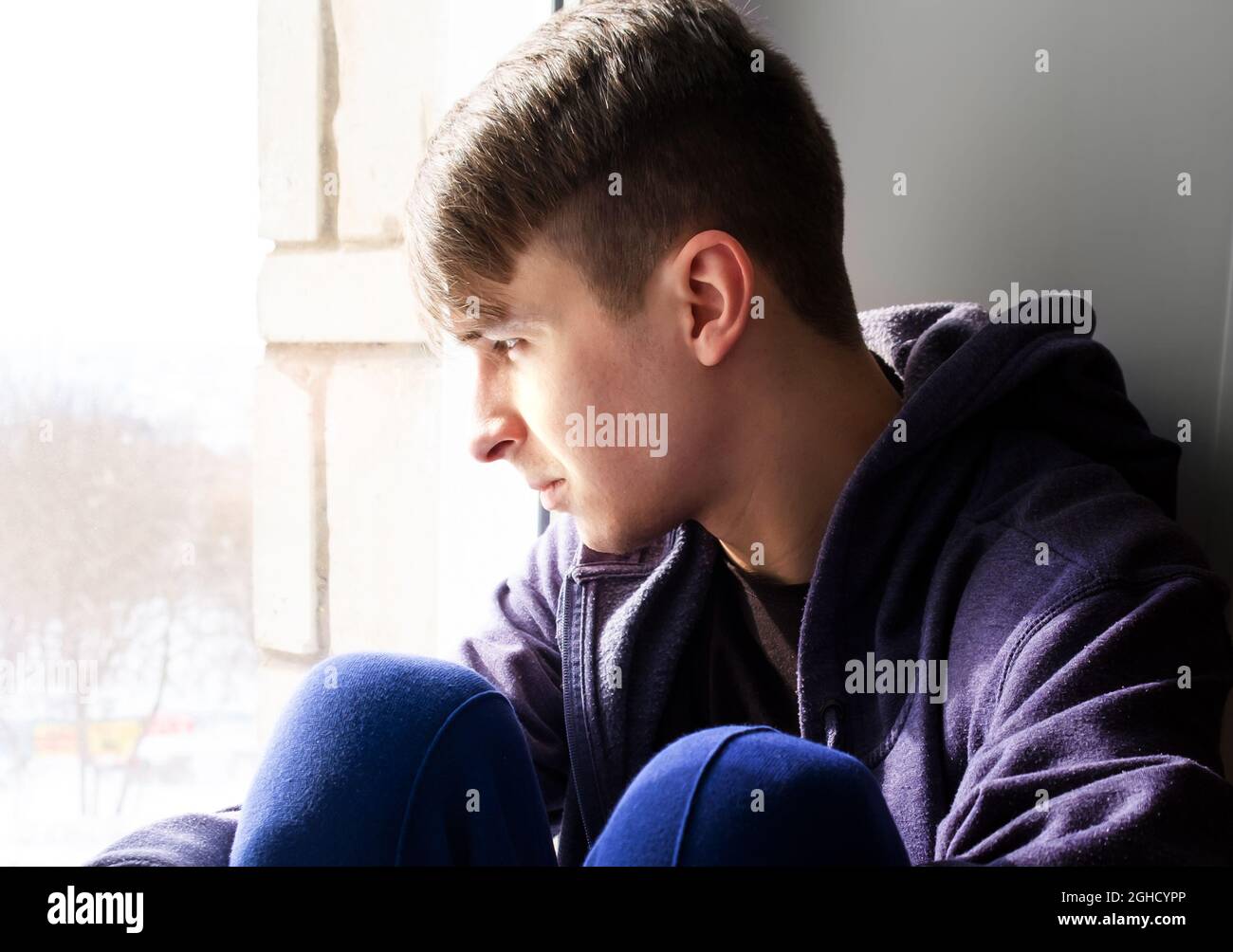 Sad and Pensive Young Man by the Window in the Room Stock Photo - Alamy