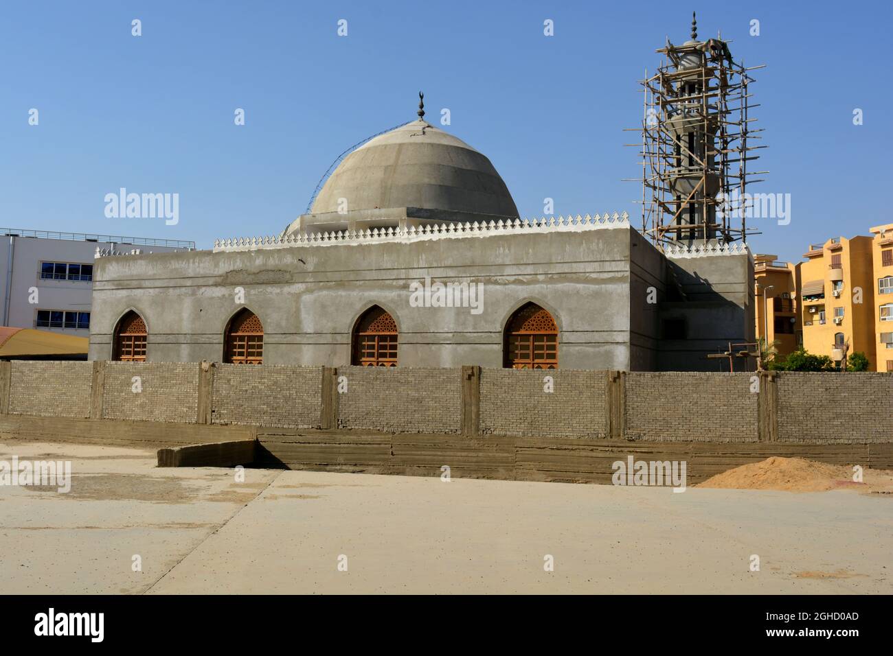 A new mosque under construction against the sunny blue sky with the ...