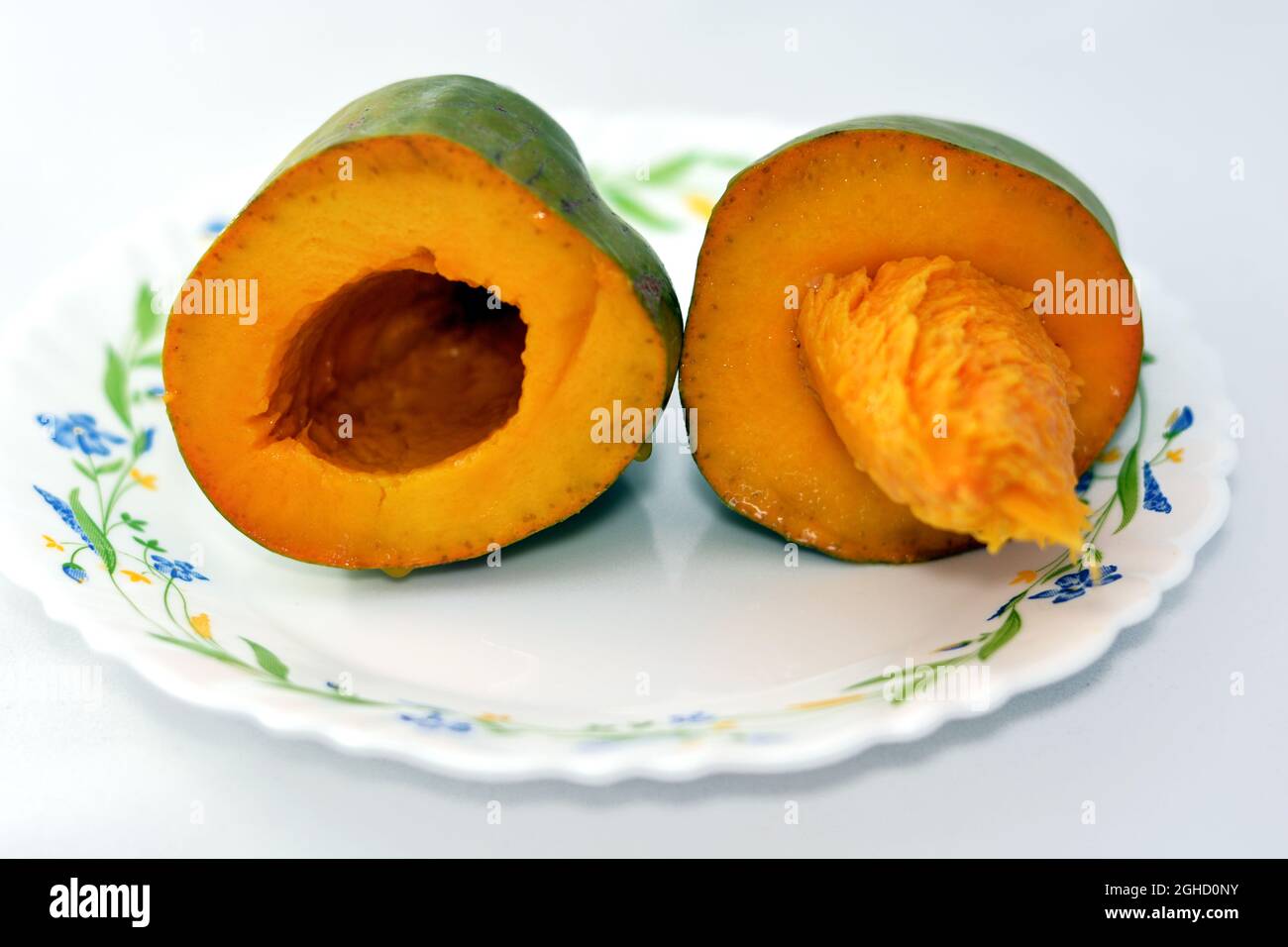Fresh sliced mangoes fruits served on a plate with a spoon isolated on ...