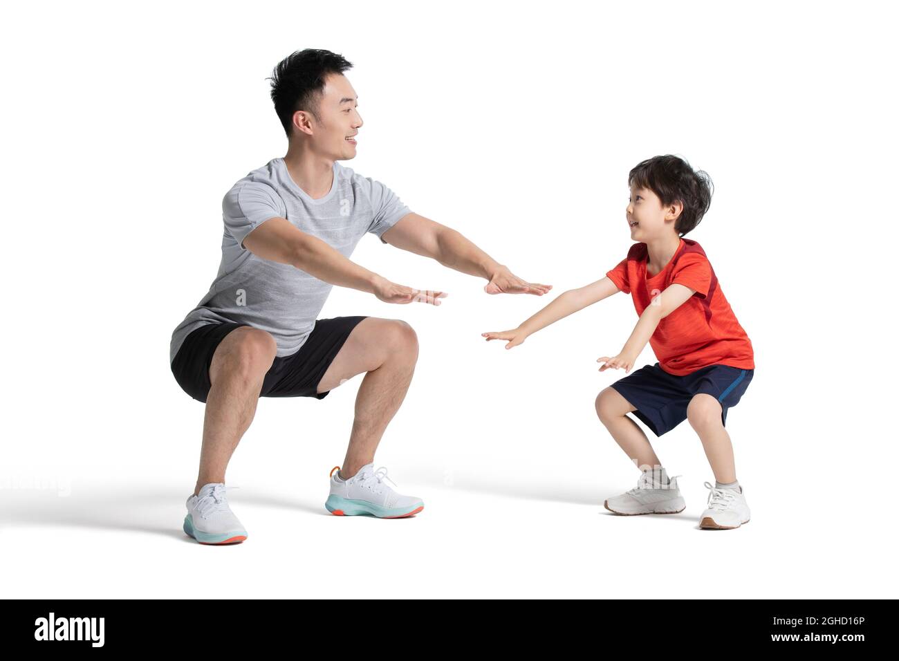Little boy exercising with his father Stock Photo - Alamy