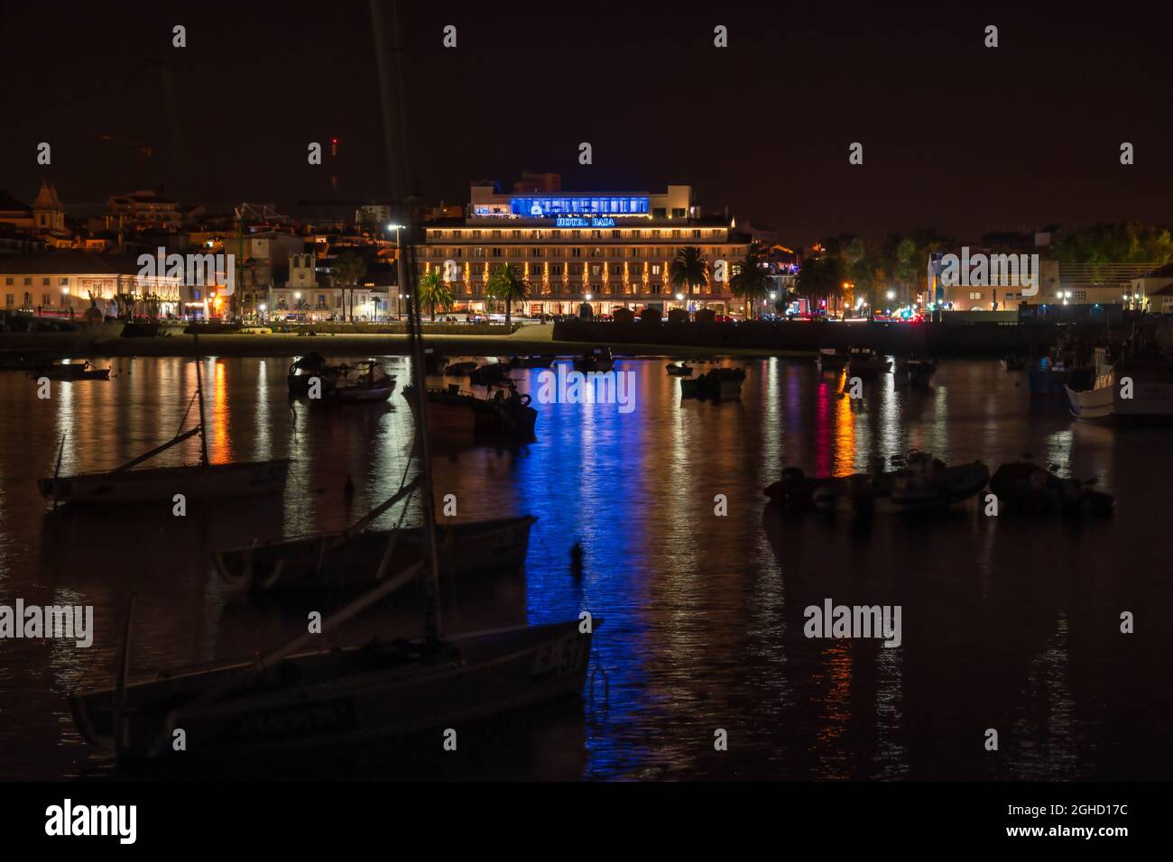 Cascais waterfront at night with illuminated buildings, boats, and ...
