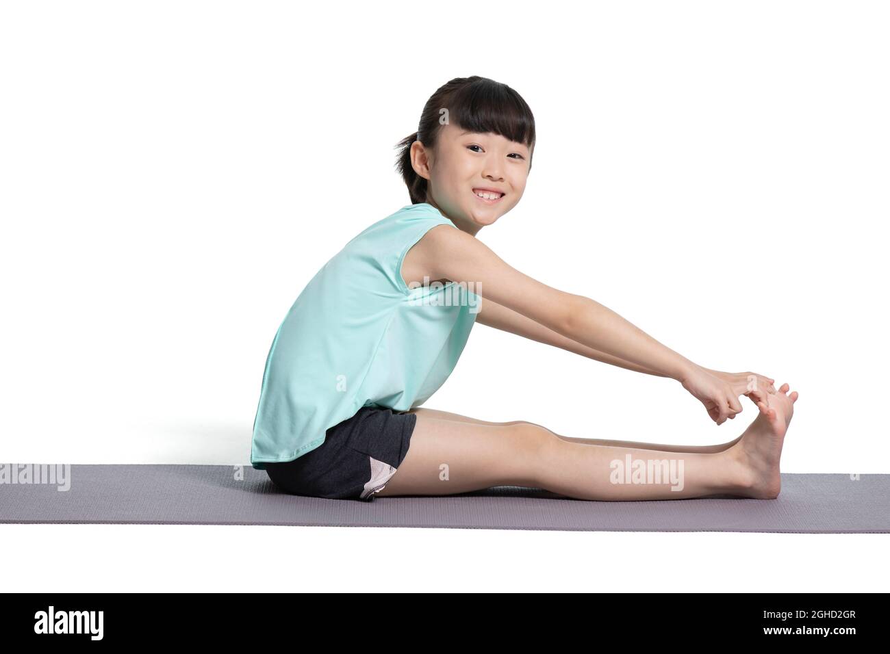 Happy little girl doing exercise Stock Photo - Alamy