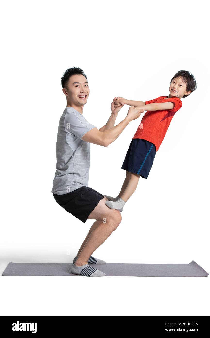 Little boy exercising with his father Stock Photo - Alamy