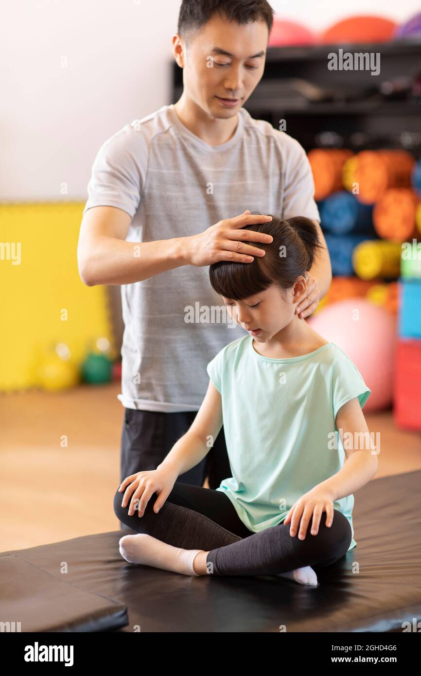 Little girl having exercise class in gym Stock Photo - Alamy